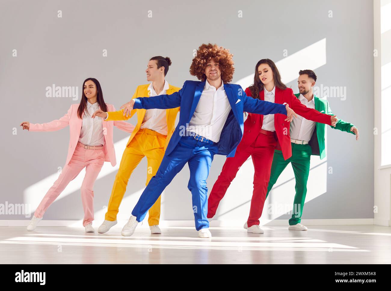 Group of five cheerful people coordinated in dance line dance dressed ...
