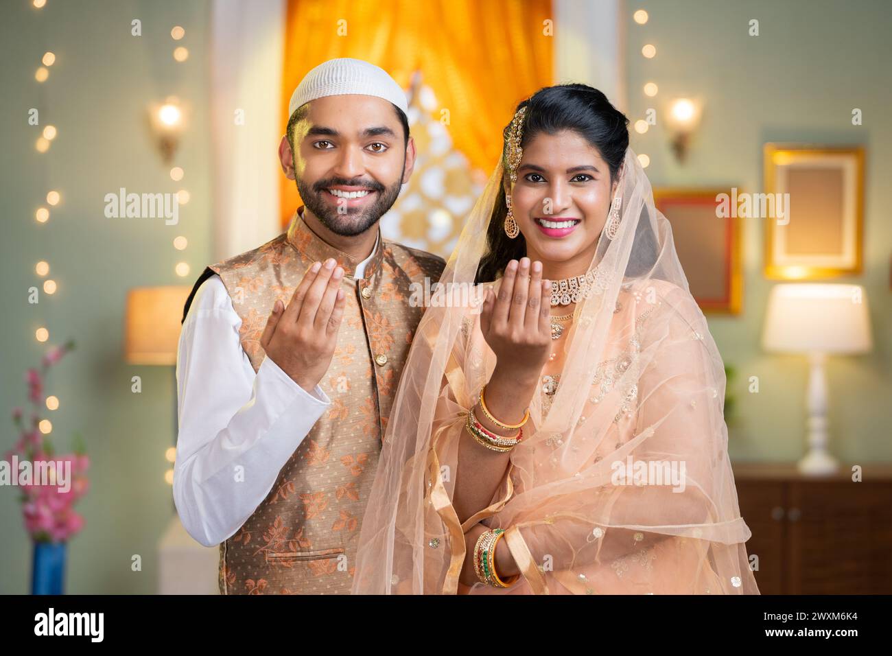 Happy indian muslim couple wishing for ramadan festival by saying with ...