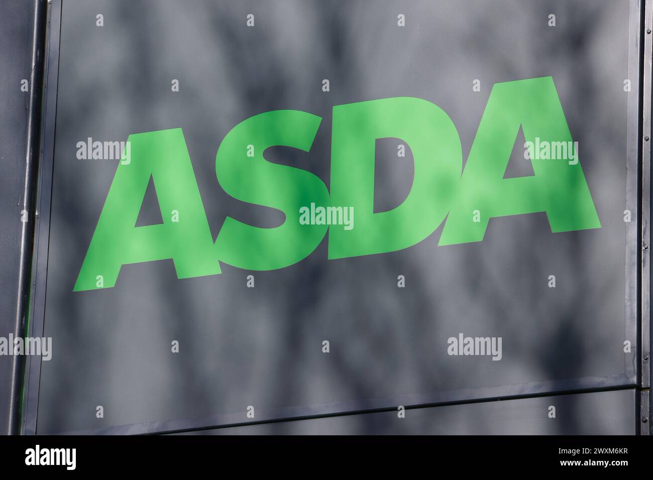 Asda sign with shadows of tree in bright sunshine in Radcliffe greater ...