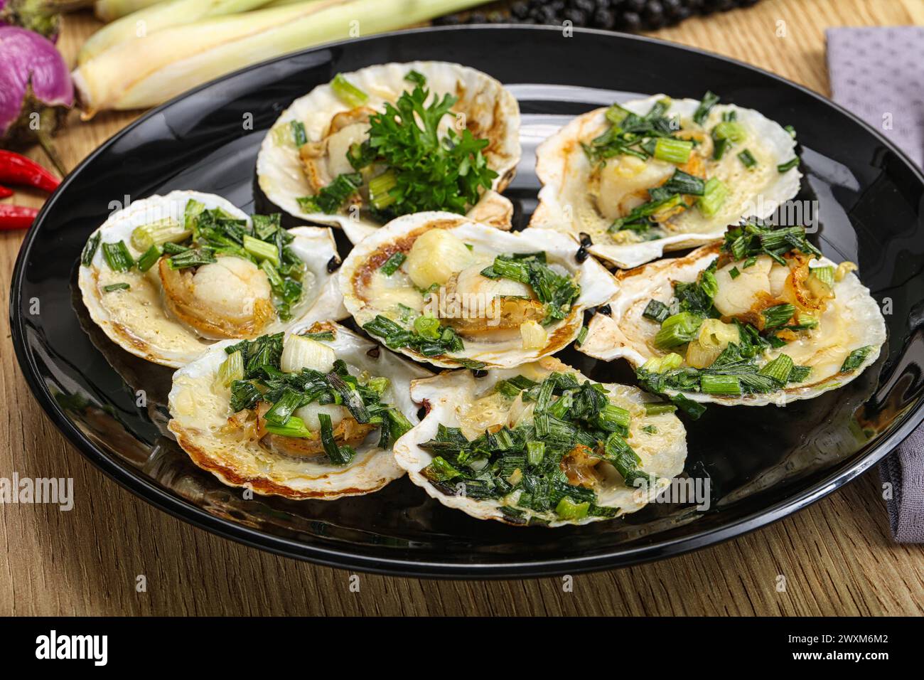 Grilled scallops with green onion and sauce Stock Photo - Alamy