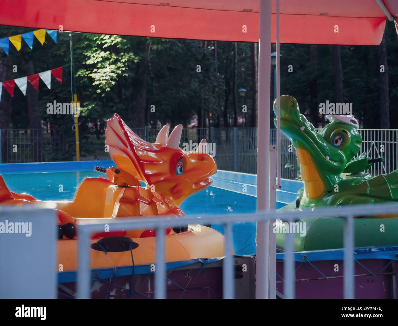 Inflatable dinosaur and alligator kids ride-on floating in a pool in ...