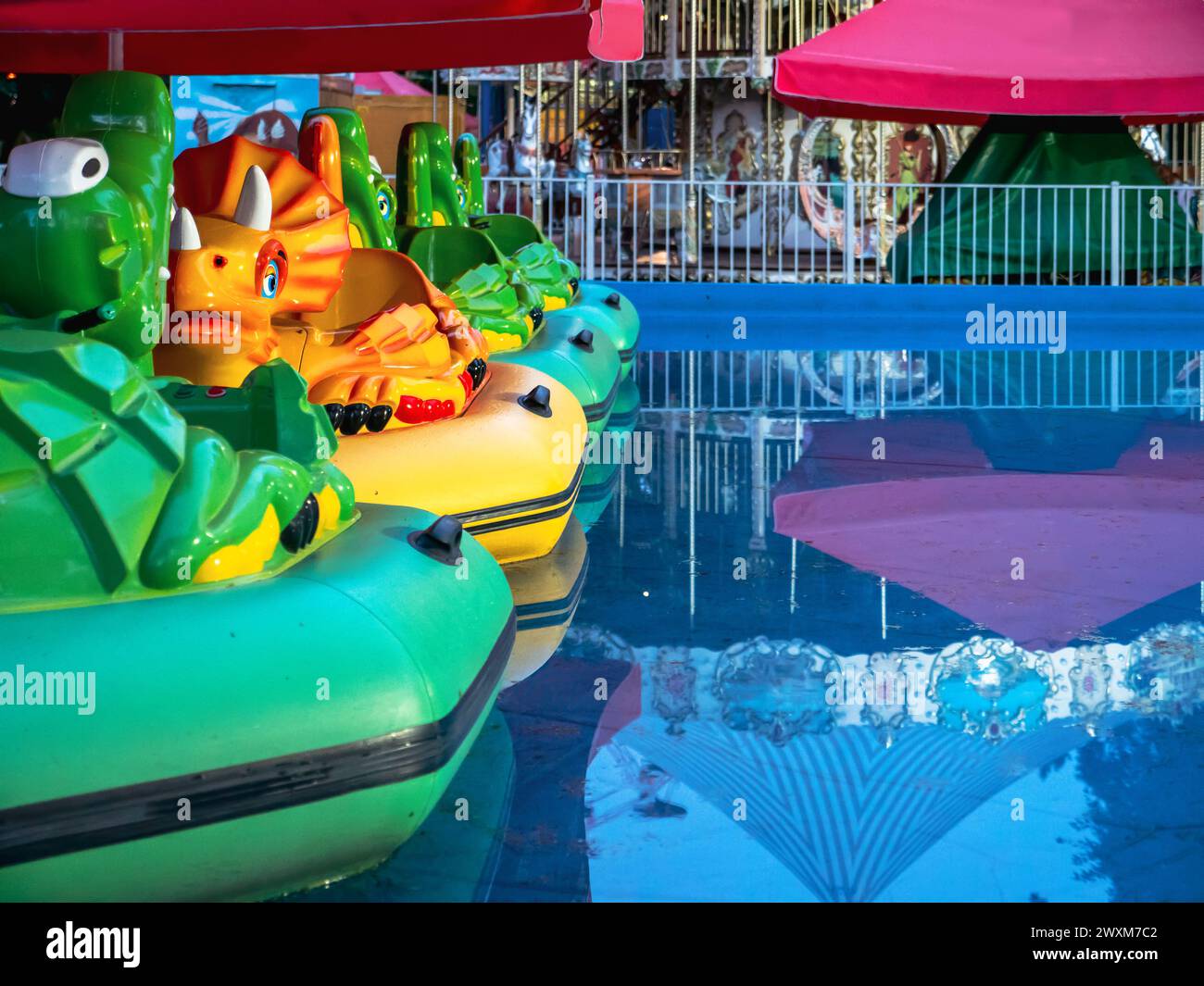Inflatable dinosaur and alligators ride-on floating in a pool, two ...