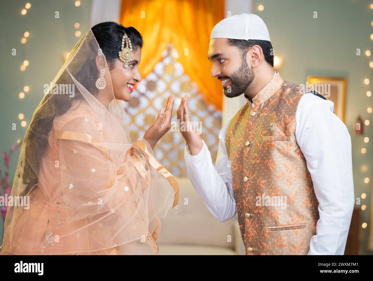 Happy indina muslim couple celebarting eid or ramadan by wishing each ...