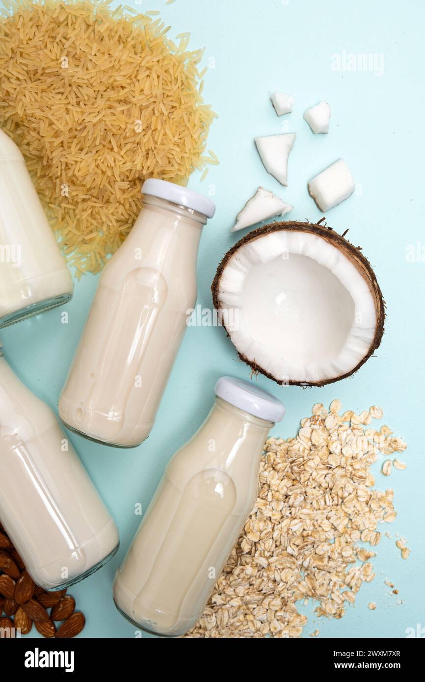 Types of plant-based milk in glass bottles. Coconut, rice, almond and ...
