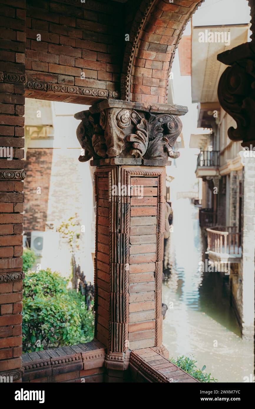 A vertical of a brick columns of a building near a water canal Stock ...