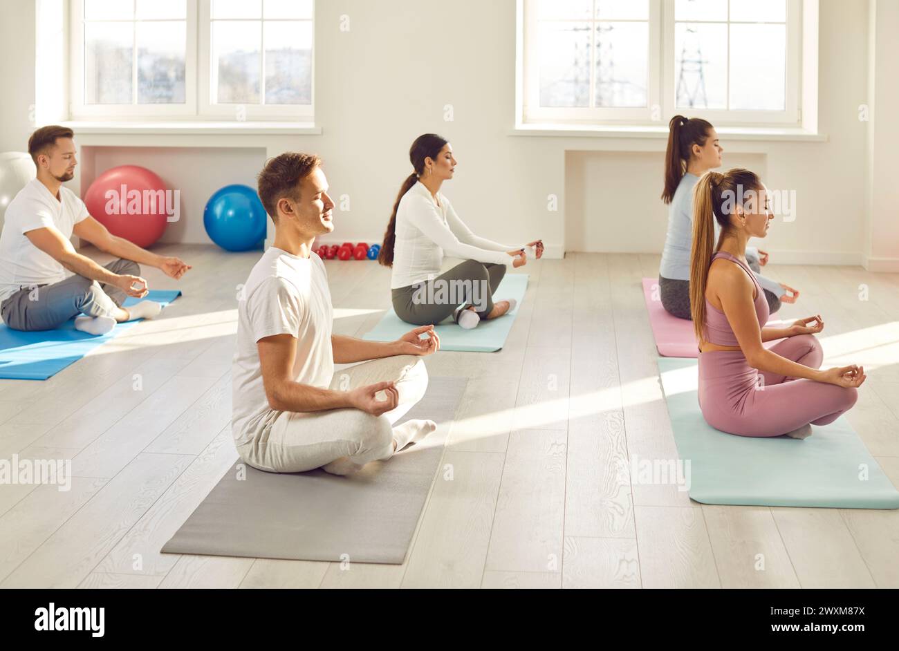 Yogi people sitting in meditation pose, sporty group doing yoga in ...