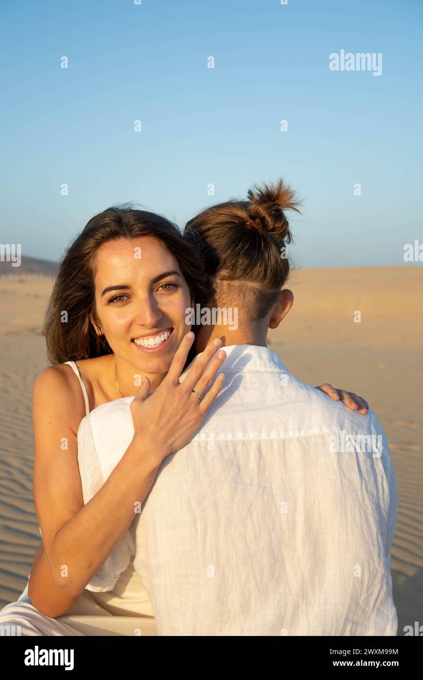 A beautiful and joyful beach proposal moment at sunset with a happy ...