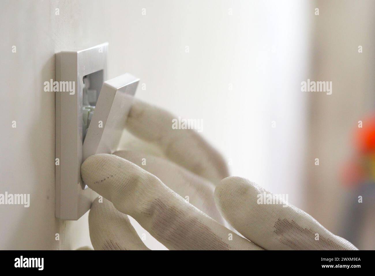 Installation of an electrical switch on the wall during the renovation ...