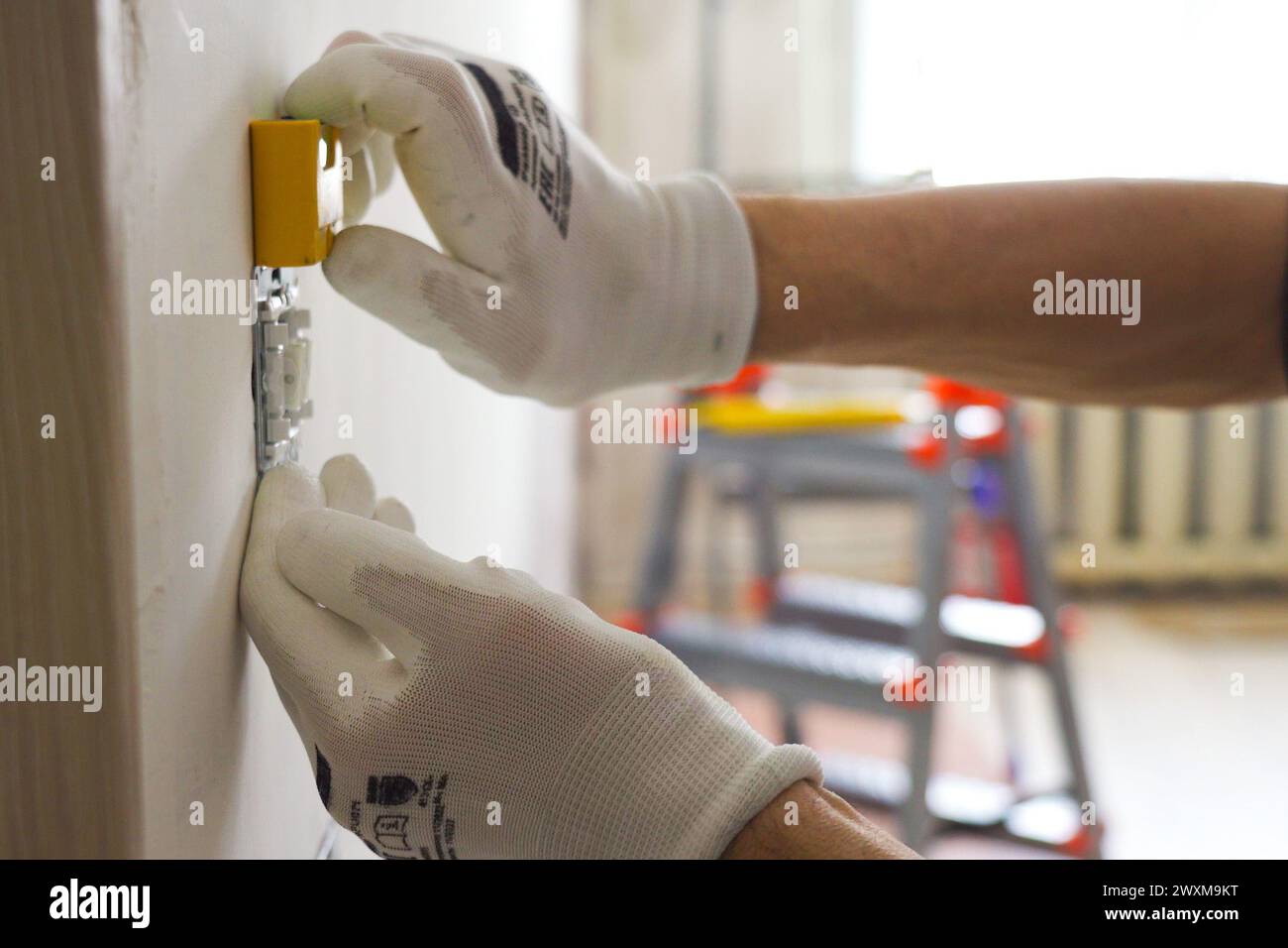 Leveling during the installation of a new electrical outlet on the wall ...