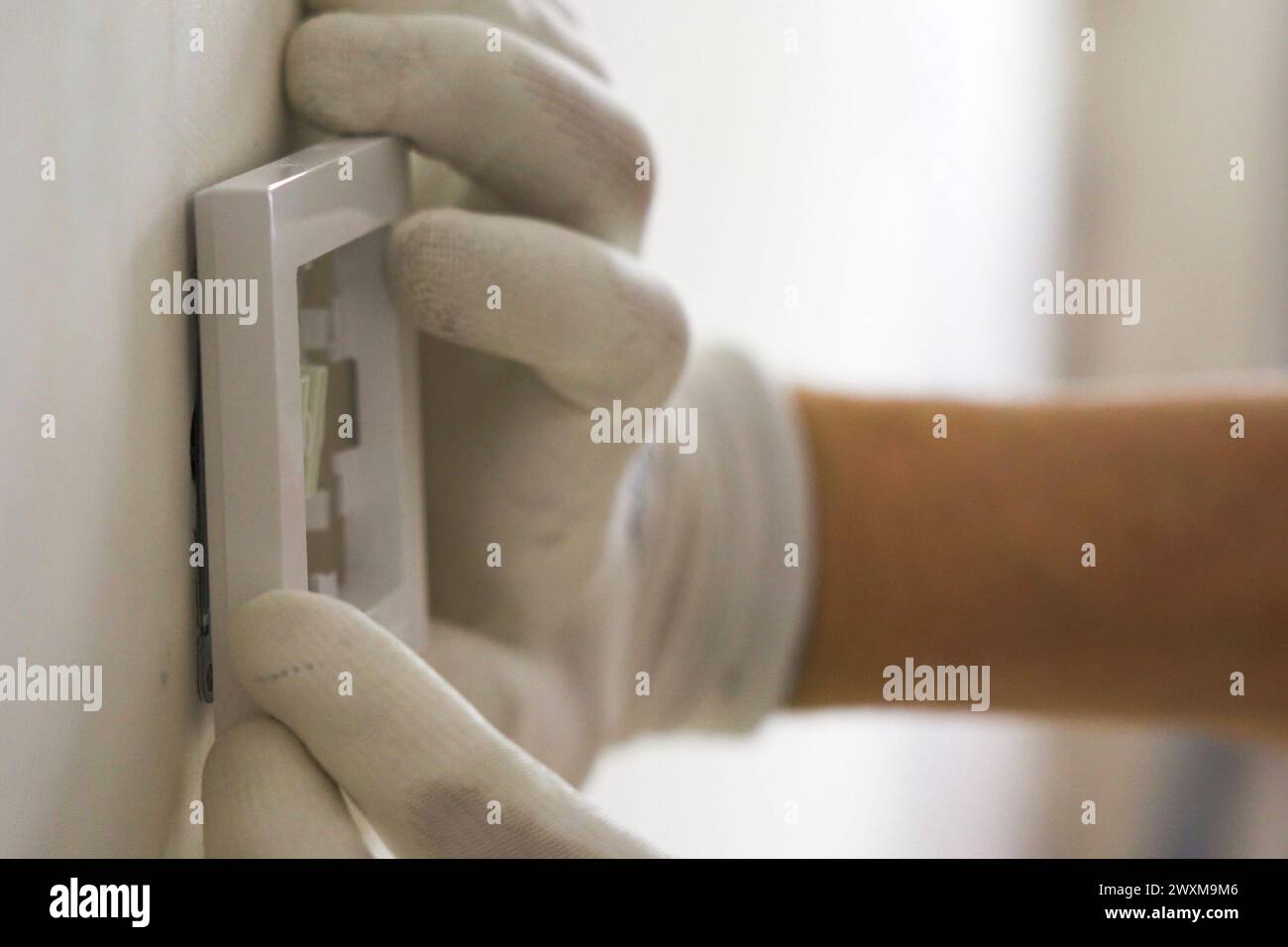 Installation of an electrical switch on the wall during the renovation ...