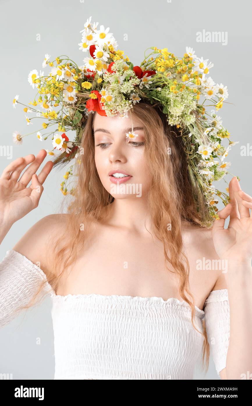 Beautiful Young Woman In Flower Wreath On Light Background Summer