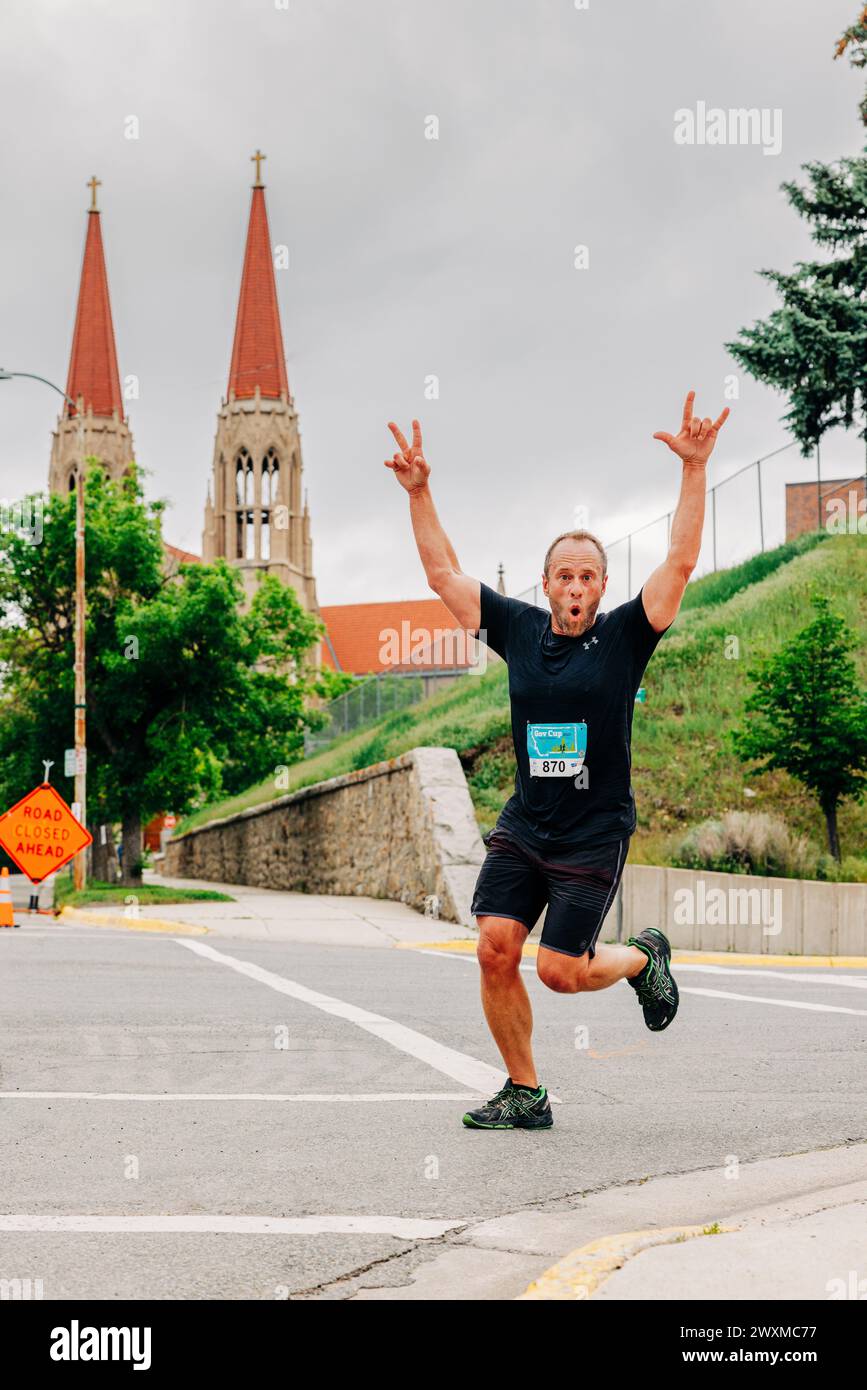 Excited man running in Governor's Cup Race with cathedral behind him ...