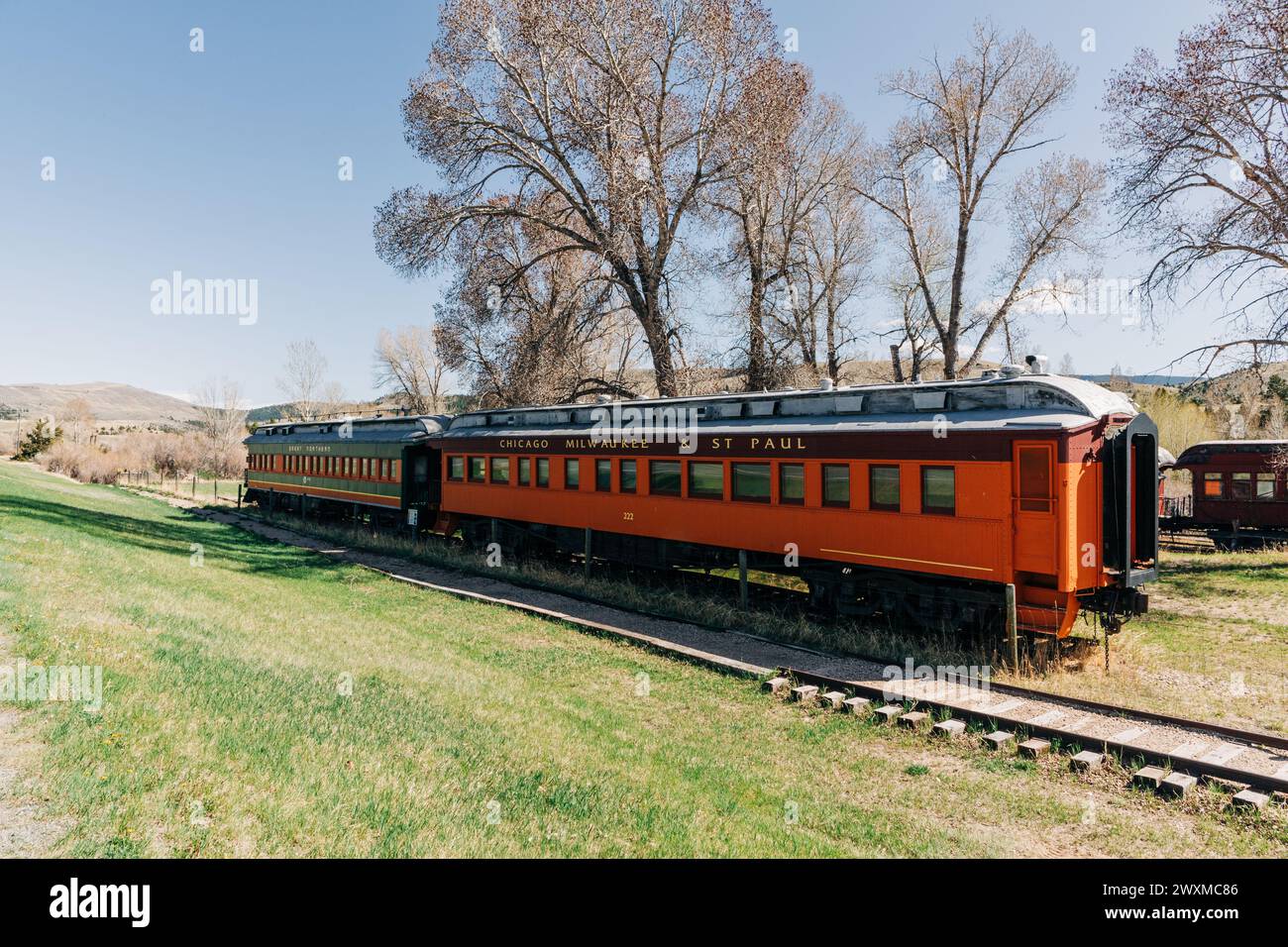 Old orange train on tracks Stock Photo - Alamy