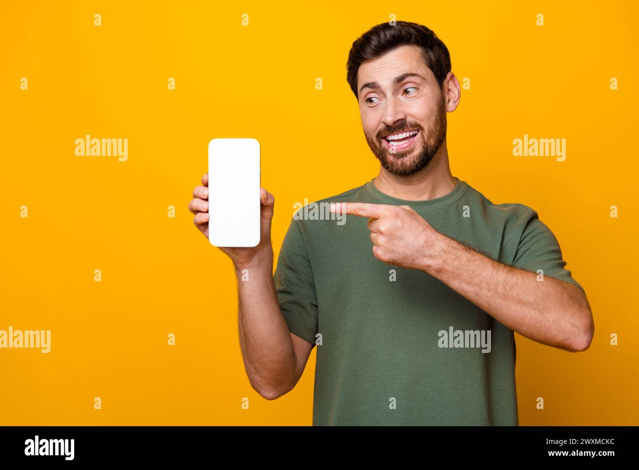 Photo portrait of handsome young guy look point white screen device ...