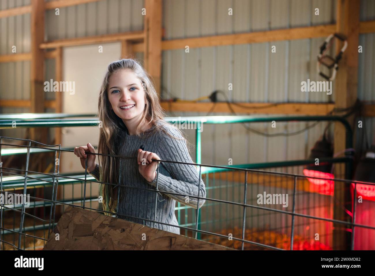 Pretty tween girl standing in barn Stock Photo - Alamy