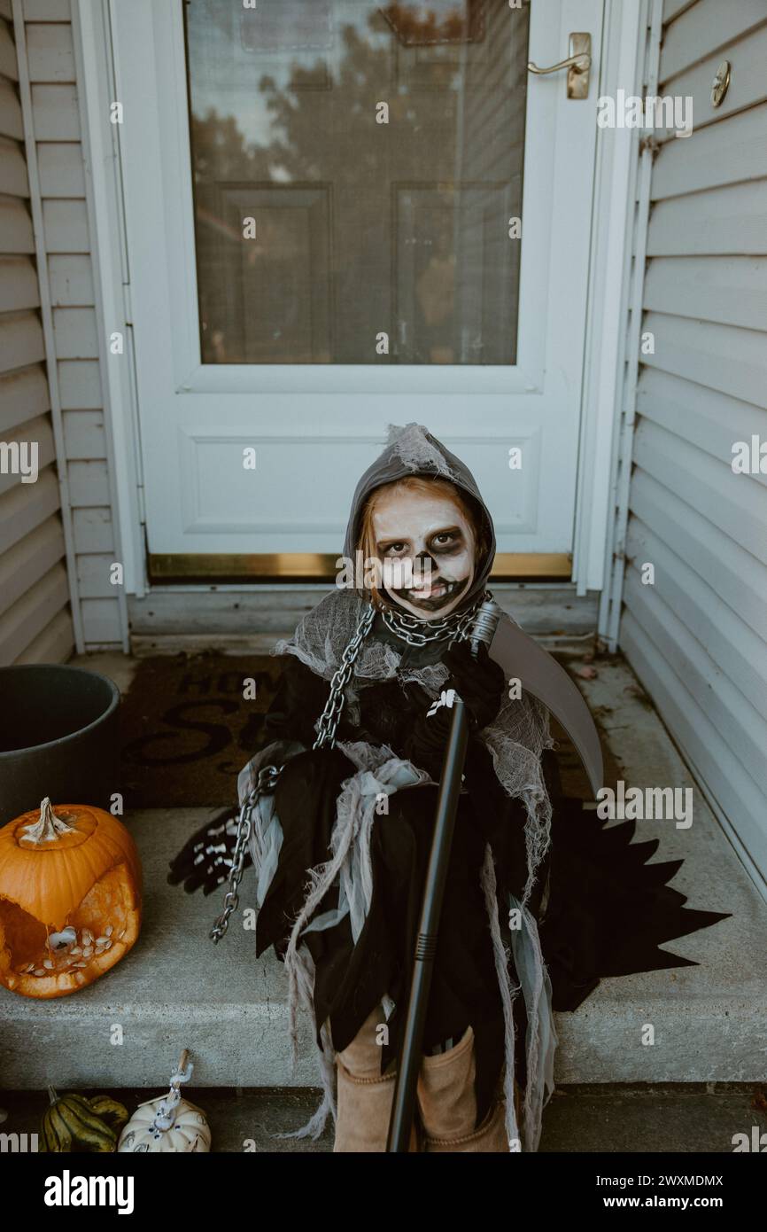 Child in Grim Reaper Halloween Costume on Front Porch Stock Photo - Alamy