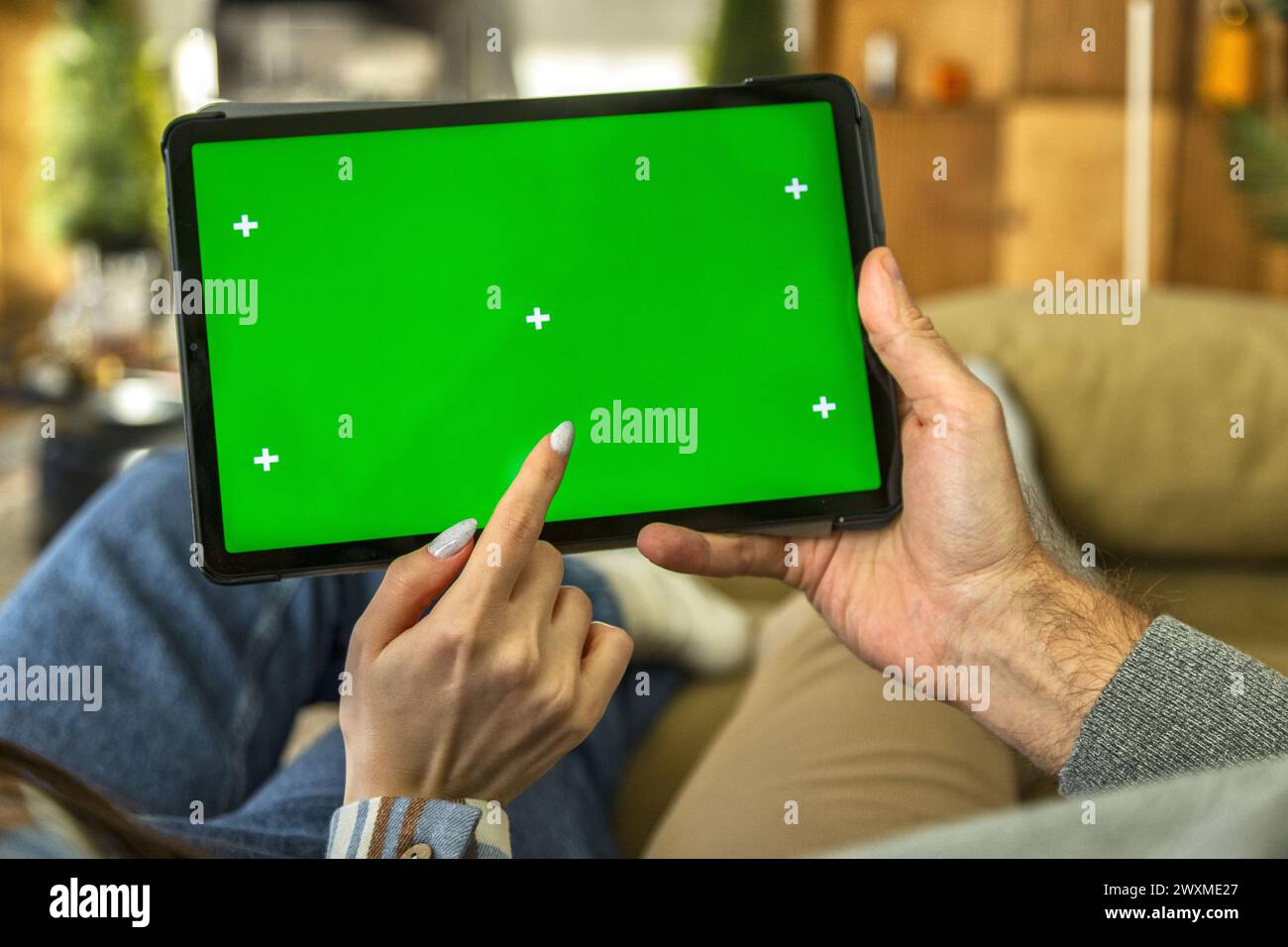 tablet screen with green chroma key display in love couple hands Stock ...