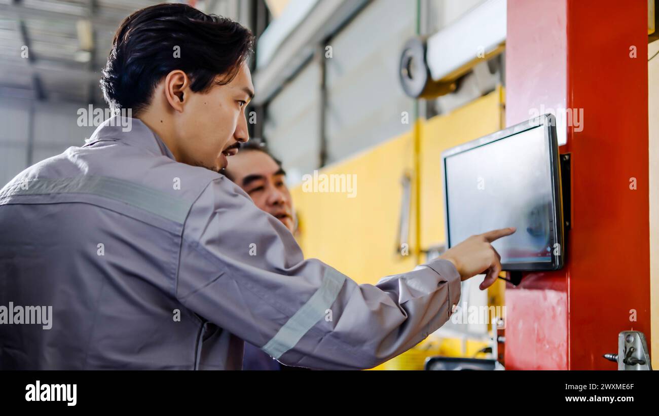 A mechanic discussing car repairment with another person in a garage ...