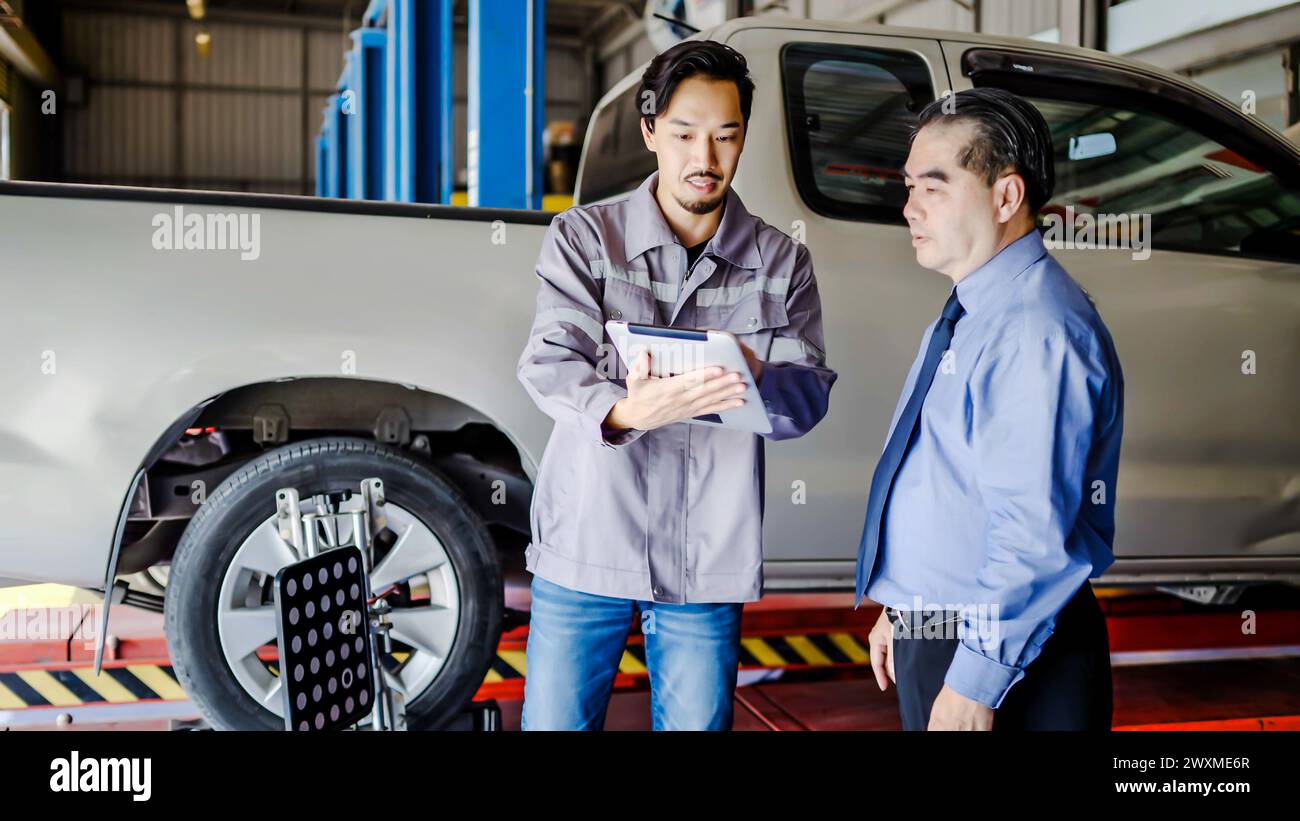 Two men standing side by side in front of a car Stock Photo - Alamy
