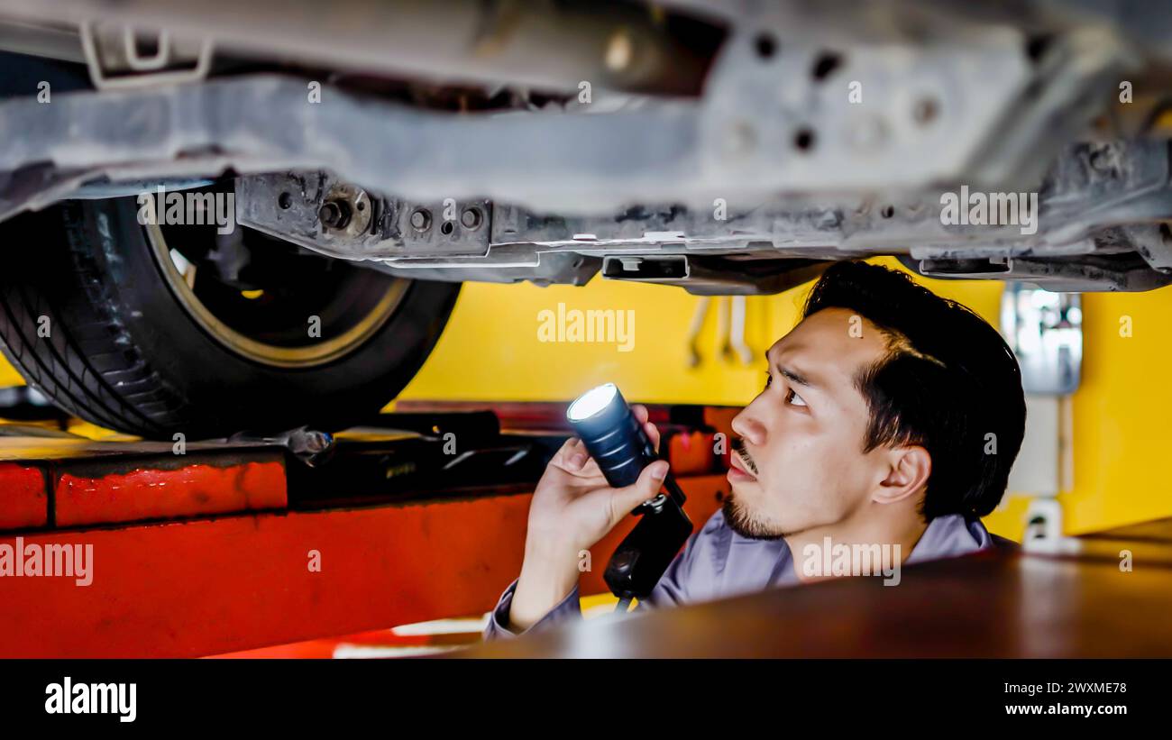 Mechanic repairing car underside in hi-res stock photography and images ...