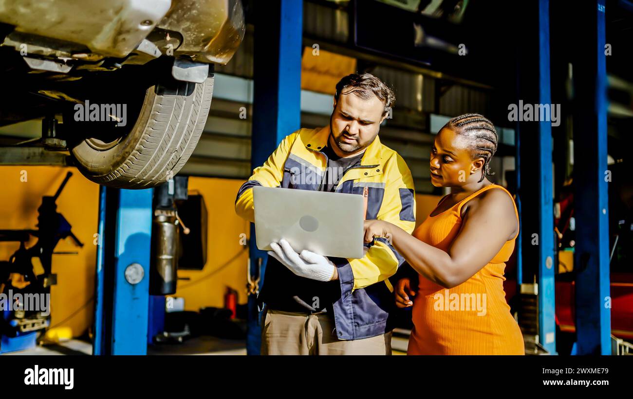Mechanics in garage workshop discussing hi-res stock photography and ...