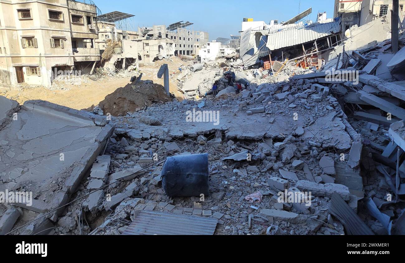 People are seen in the area where Al-Shifa Hospital and its surrounding ...