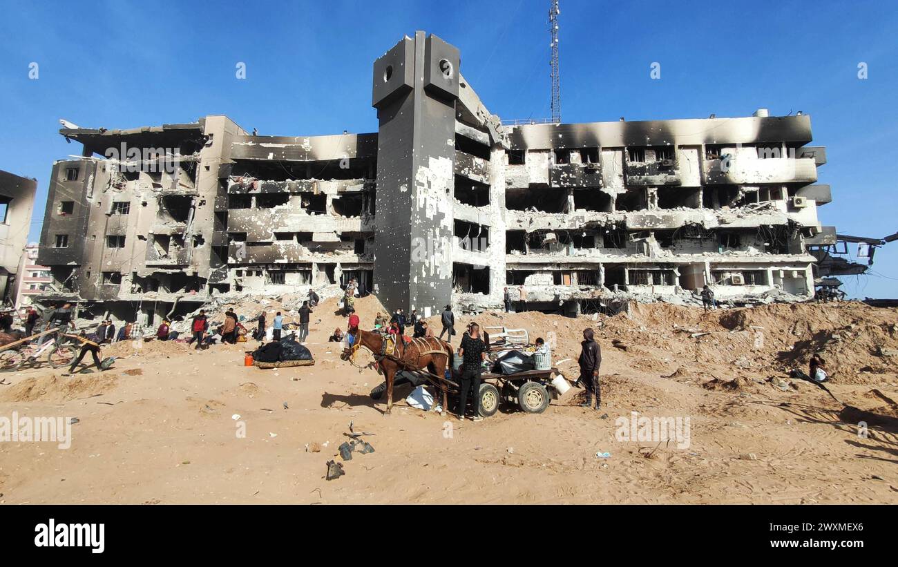 People are seen in the area where Al-Shifa Hospital and its surrounding ...