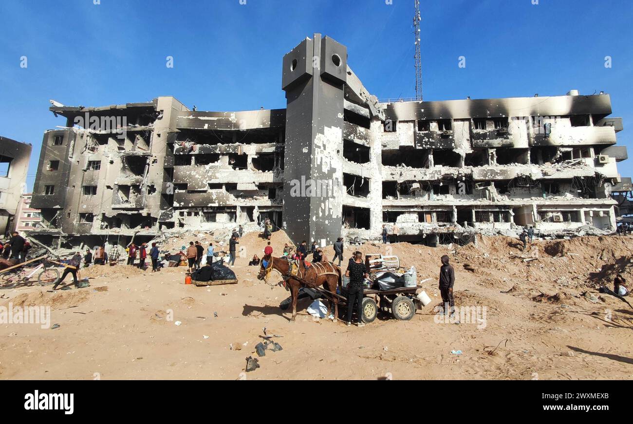 People are seen in the area where Al-Shifa Hospital and its surrounding ...