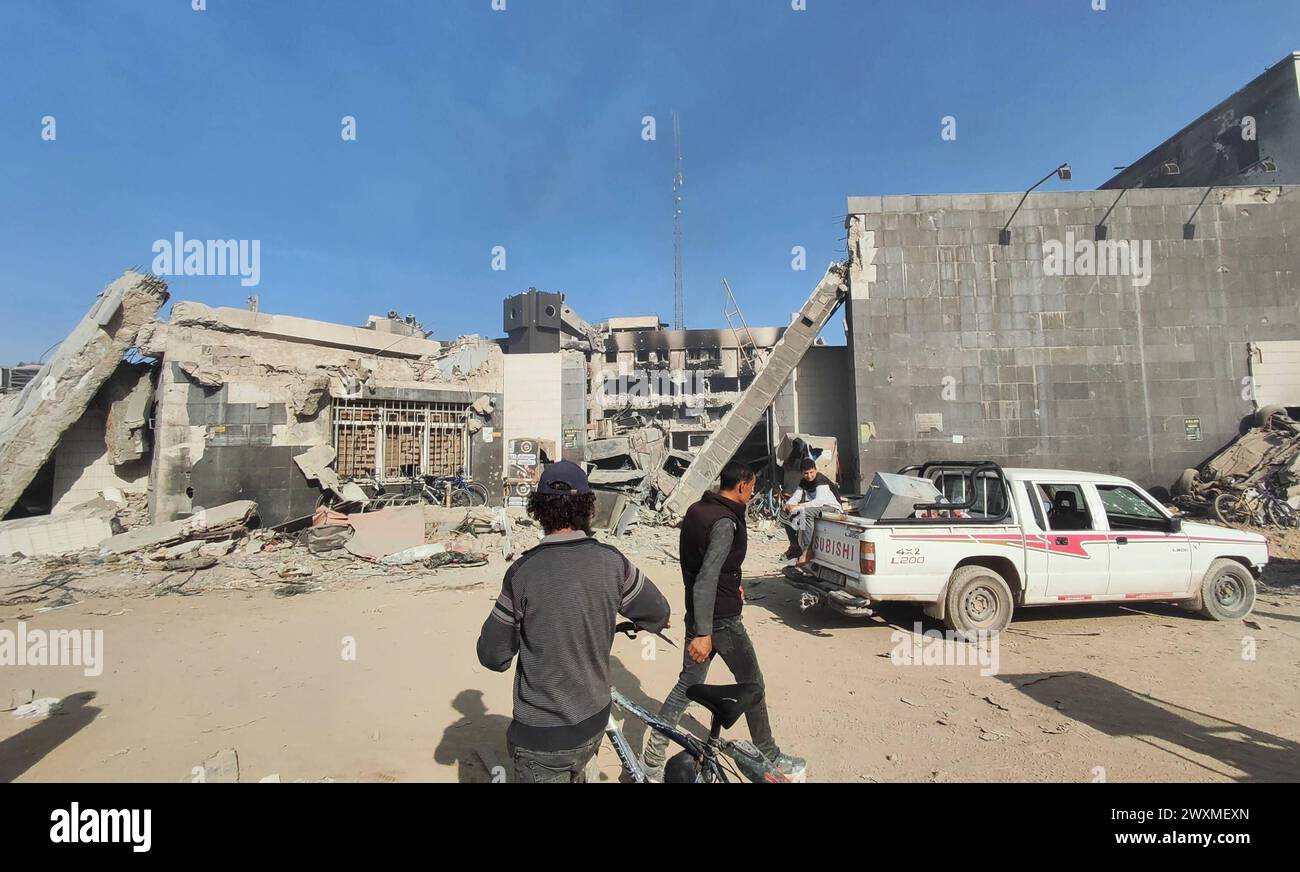 People are seen in the area where Al-Shifa Hospital and its surrounding ...
