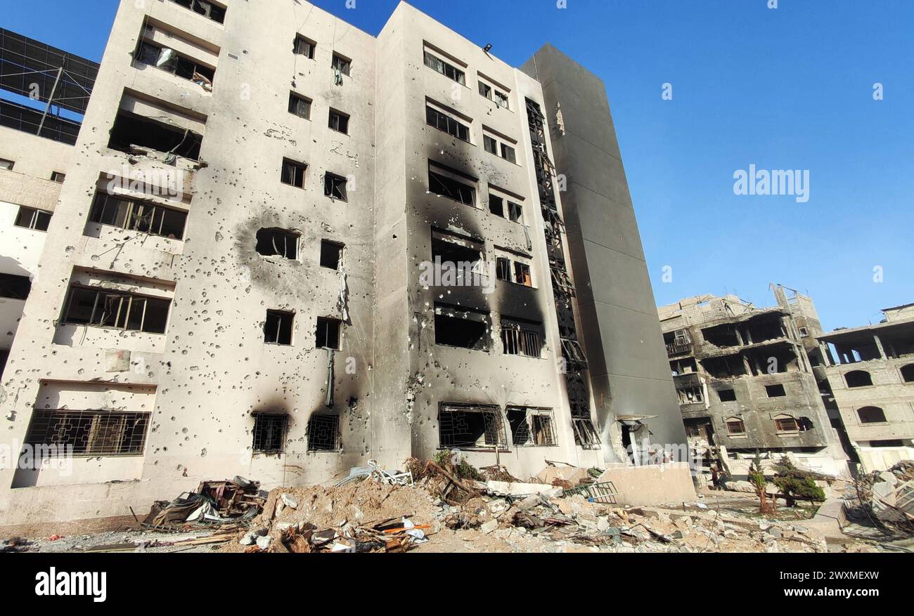 People are seen in the area where Al-Shifa Hospital and its surrounding ...