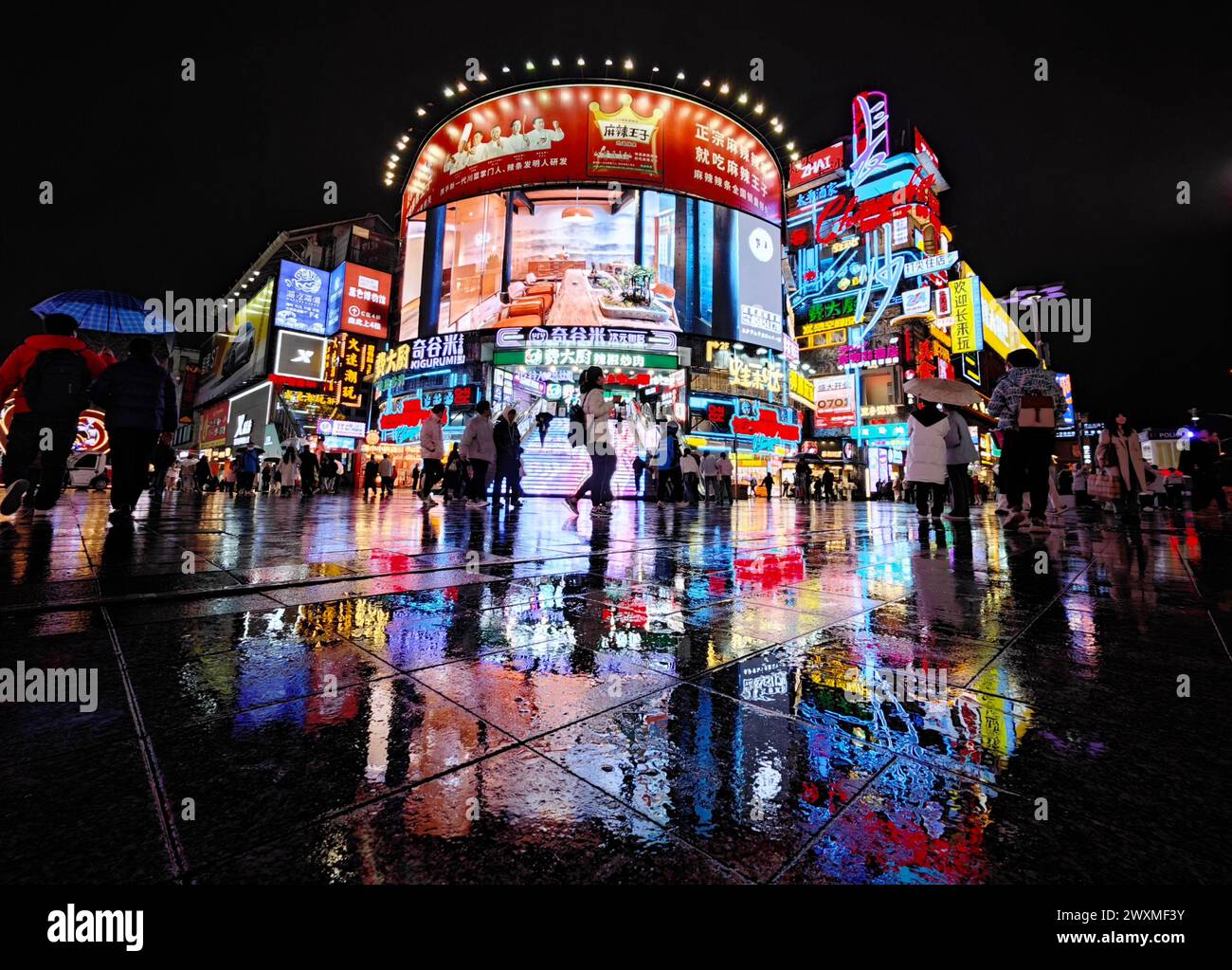 colorful lightboxes and signboards are reflected in water at night ...