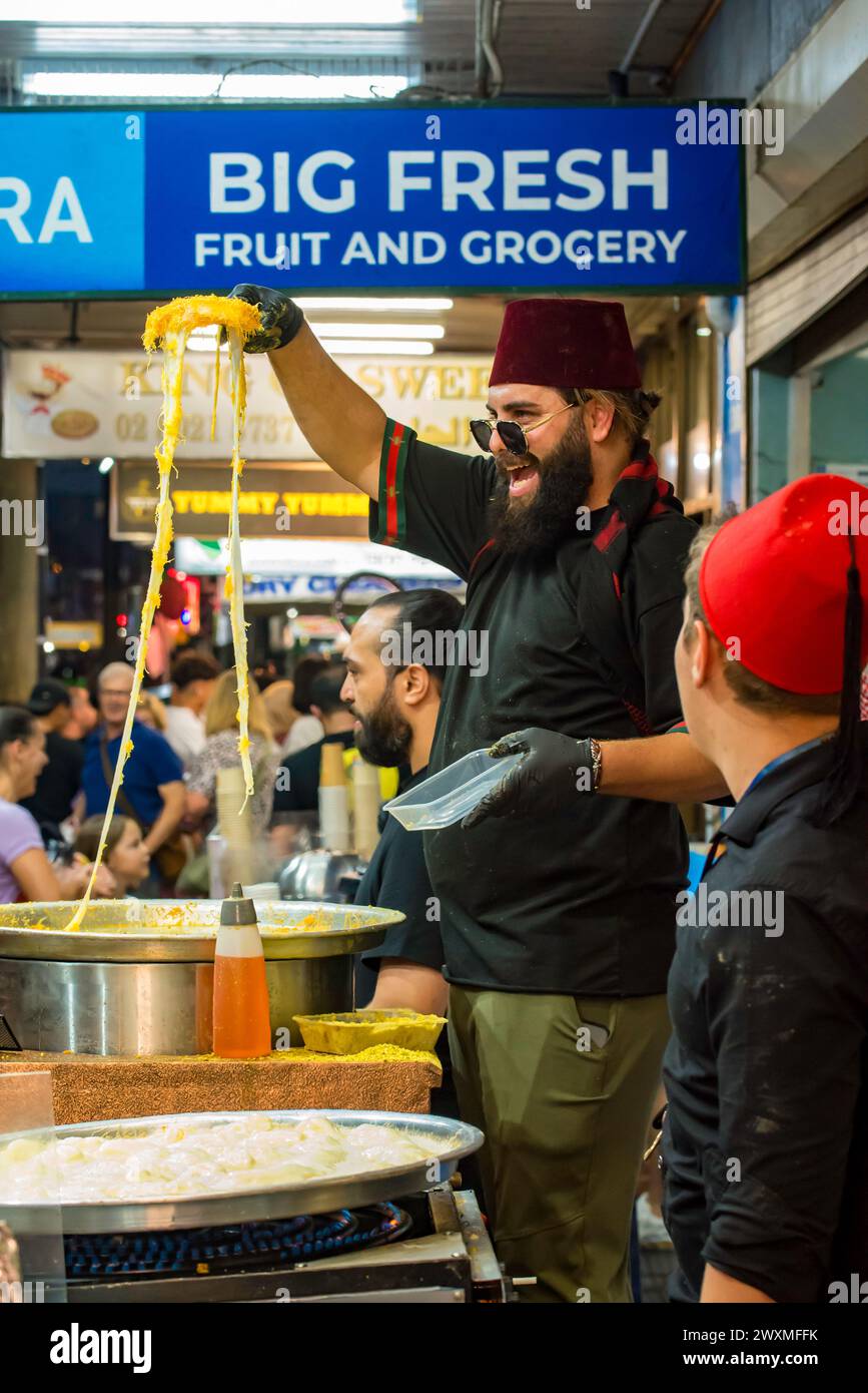 A man preps a serve of stringy cheesy Kenefe Abou (knafeh or kunafa) at ...
