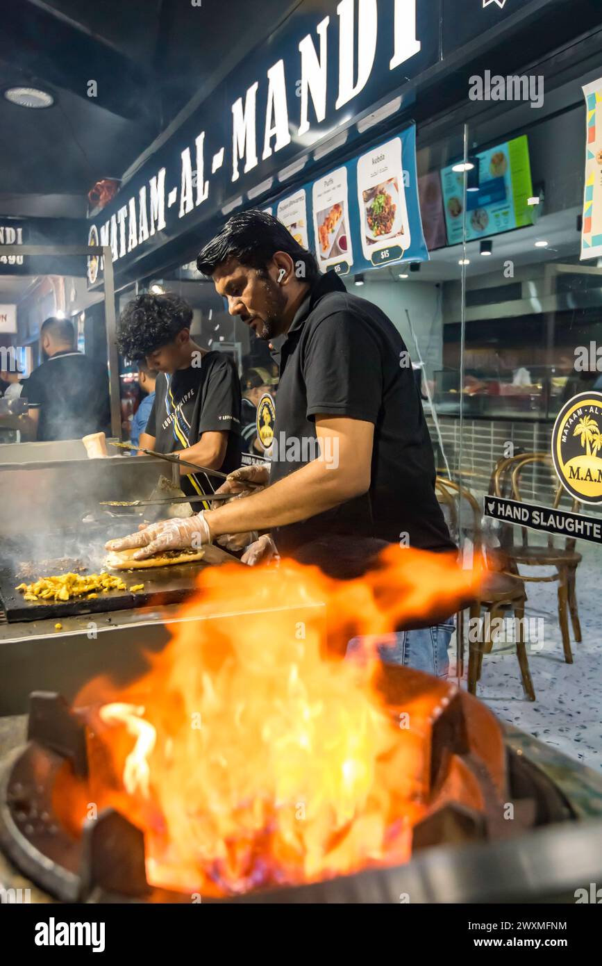 Men cooking Mandi, a Yemeni traditional dish at a street stall in ...