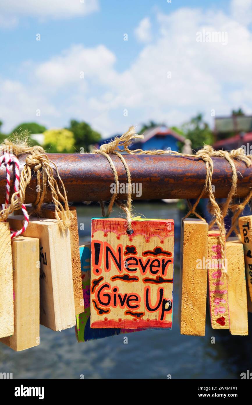 Wooden Plaque with Inspirational Quote Hanging on the Bridge Railing ...