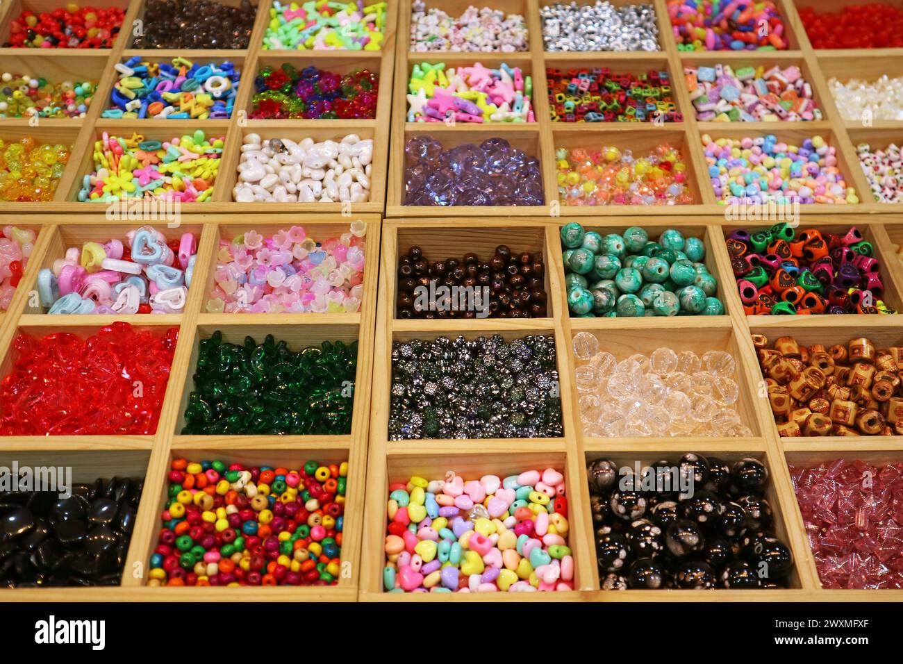 Variety of Colors and Shapes of Beads in Wooden Compartment Display ...
