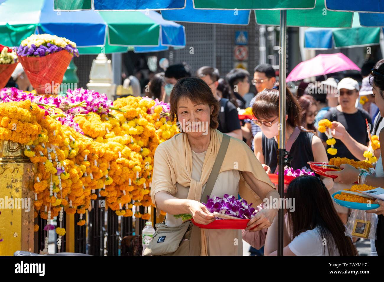 Bangkok, Thailand. 30th Mar, 2024. An Asian woman is seen carrying a ...