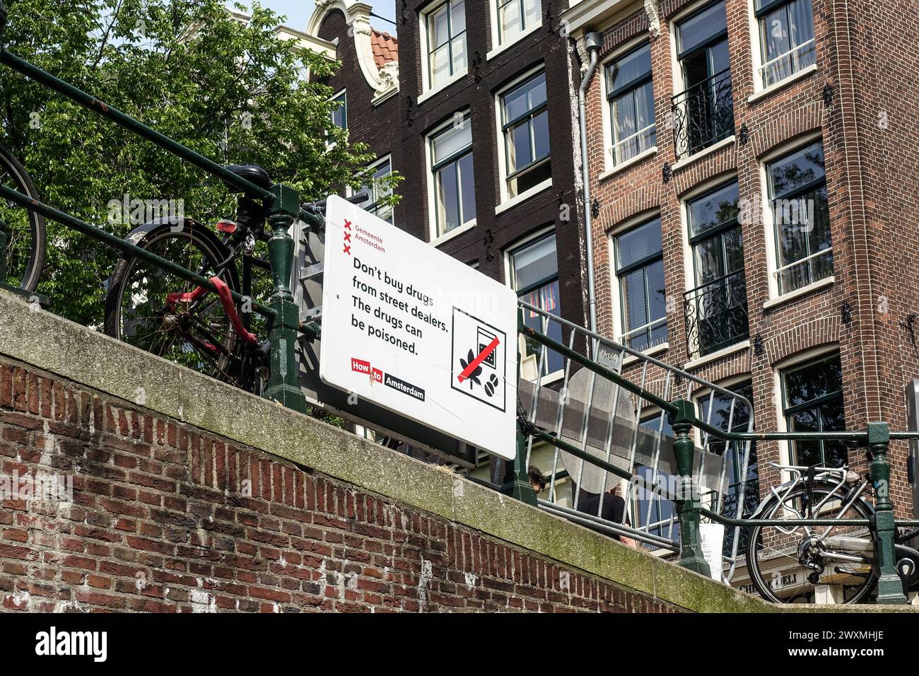 Public safety sign warning against drug use displayed on a canal bridge ...