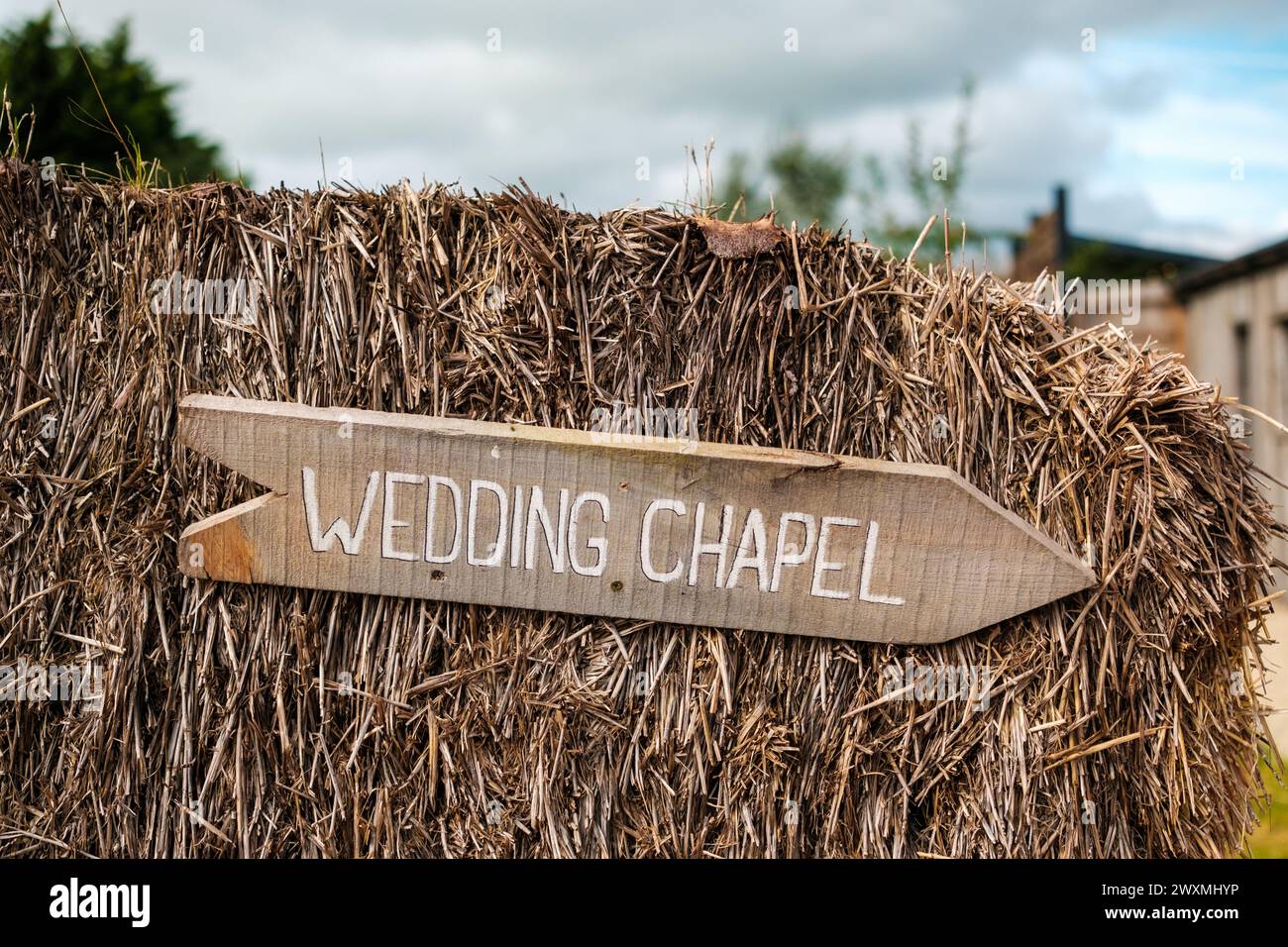 Wedding Chapel wooden sign post on a hay bale. Rustic farm wedding barn ...
