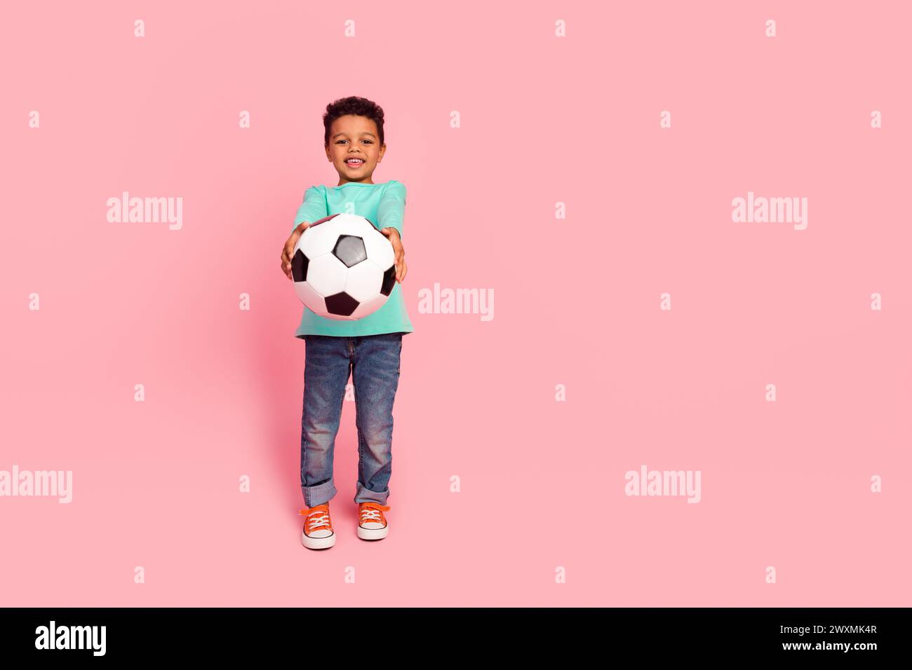 Full body photo of cute little boy hold soccer ball play football ...