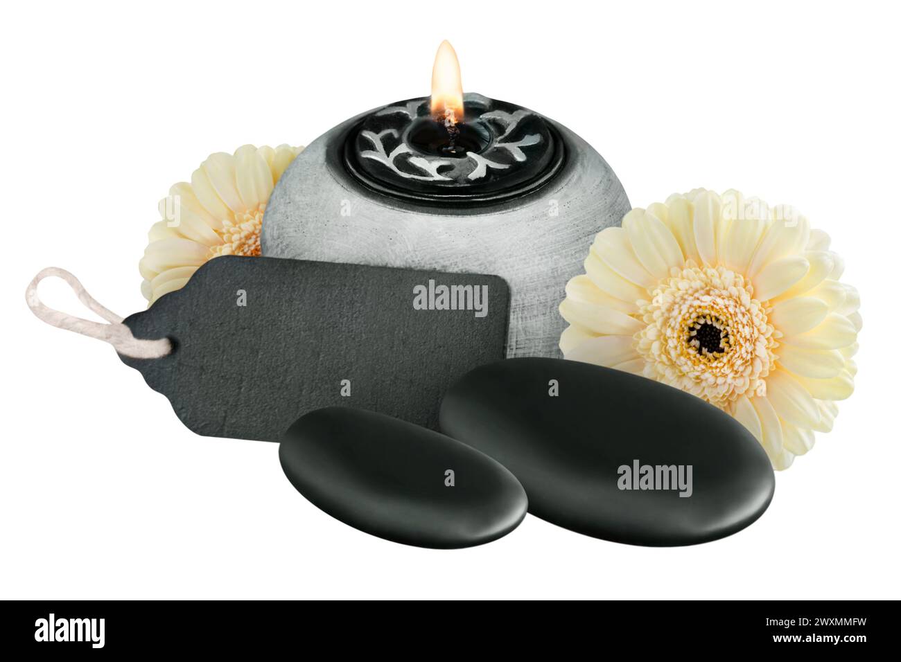 Candle with label, flowers and healing massage stones isolated on white ...