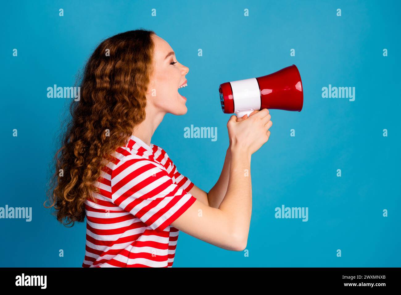 Side profile photo of adorable woman with wavy hairdo dressed striped t ...