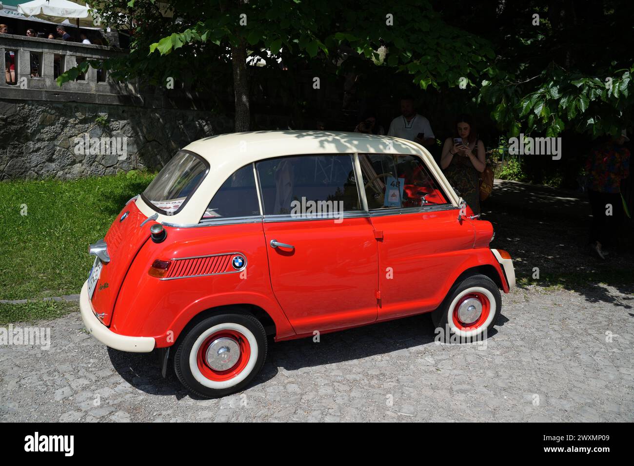 A red and white BMW Isetta 600 parked on a cobblestone road Stock Photo ...