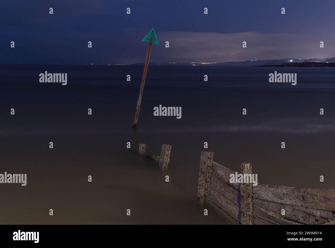 Triangular sea marker at the end of a decaying a groyne, Exmouth Devon ...