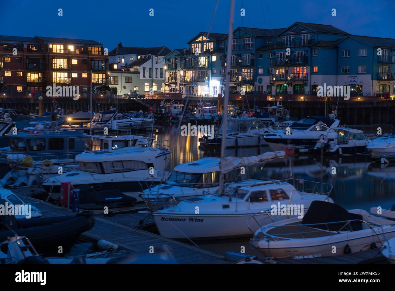 An illuminated harbour as nightfall's over Exmouth Devon England UK ...