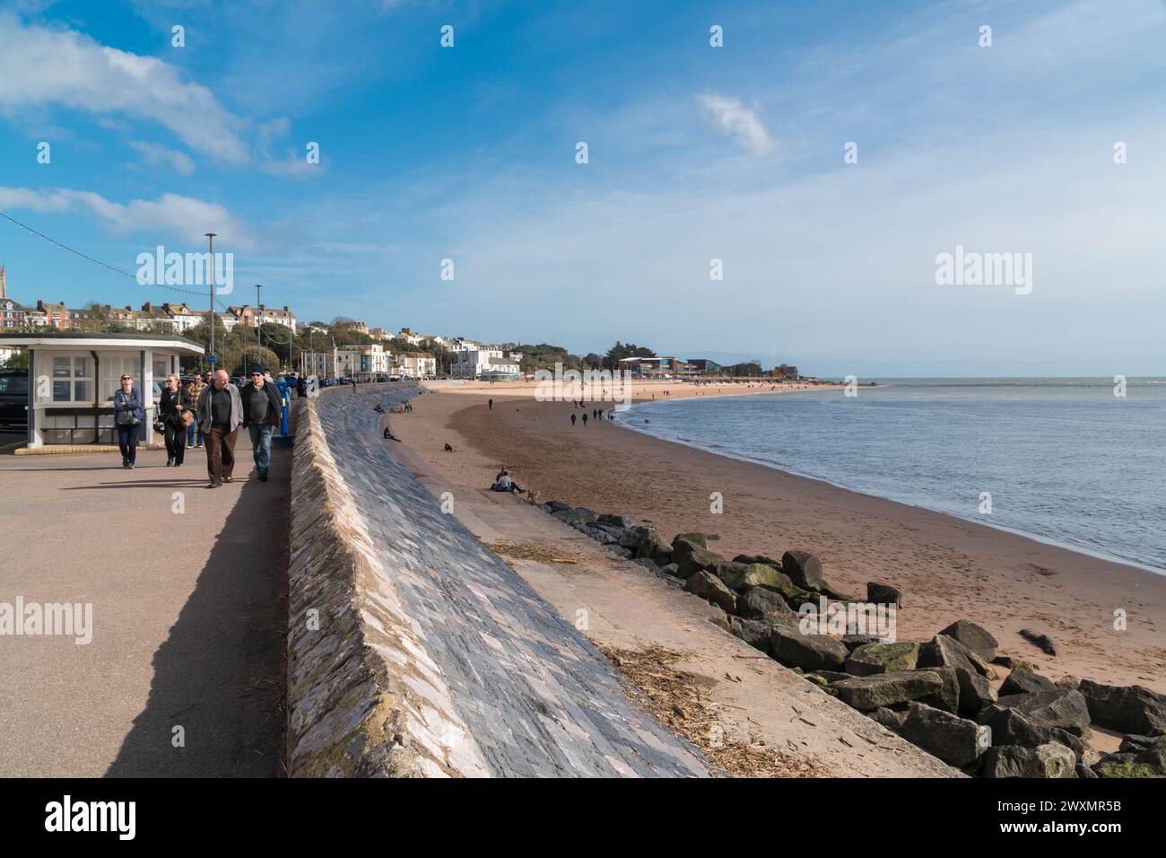 View along a busy Exmouth promenade and beach, Devon England UK. March ...