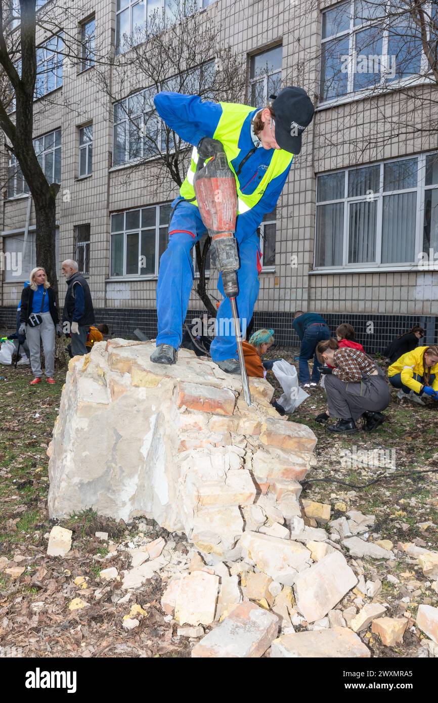 KYIV, UKRAINE - Mar. 30, 2024: Students and volunteers remove debris at ...