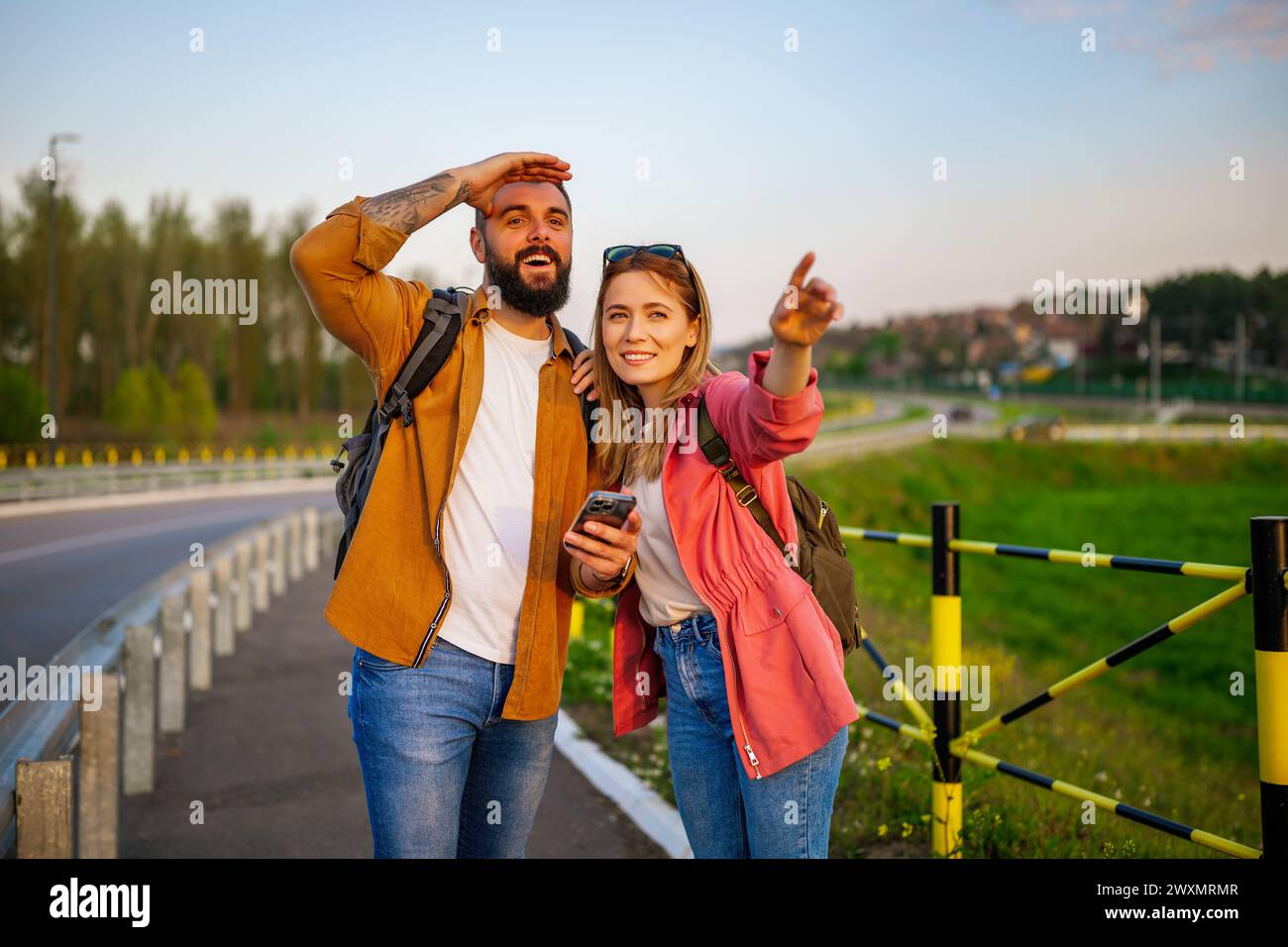 Happy smiling couple are using maps on smartphone in the city. Tourists ...