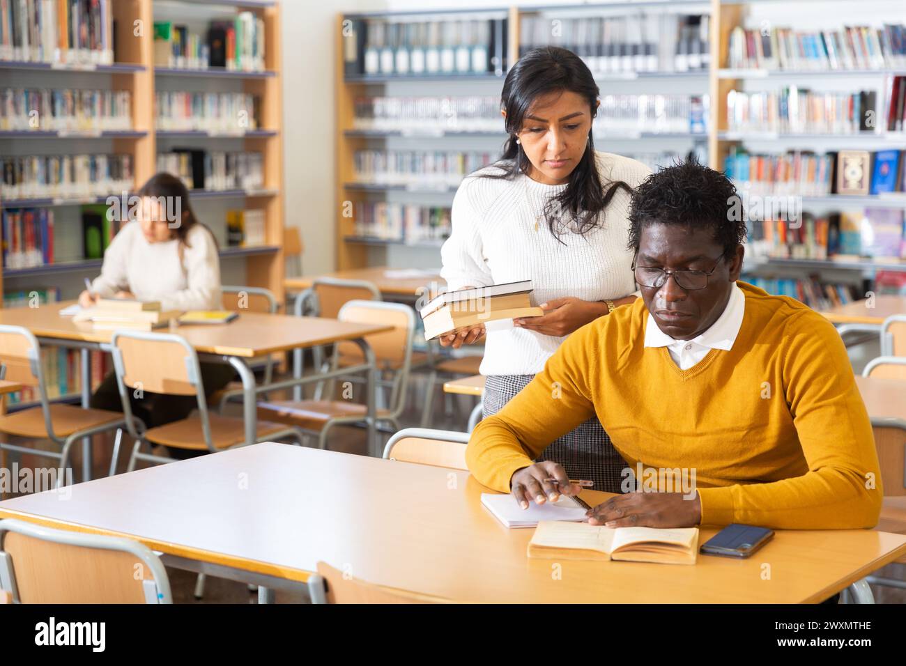Student librarian talking hi-res stock photography and images - Alamy