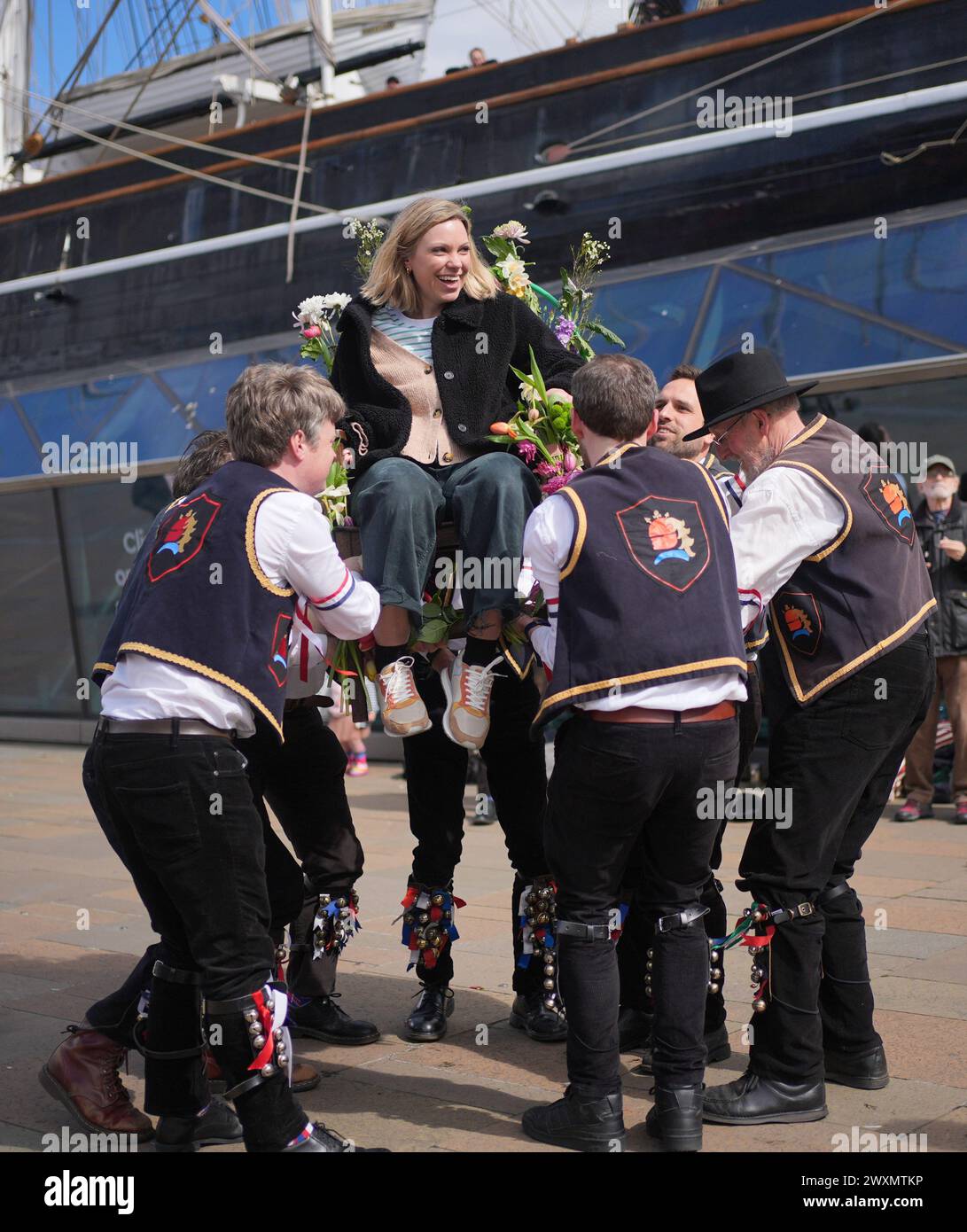 Members of the Blackheath Morris Men lift Poppy Trevillion, from London ...