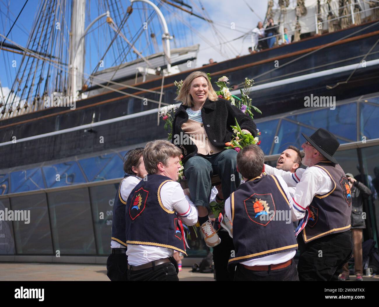 Members of the Blackheath Morris Men lift Poppy Trevillion, from London ...